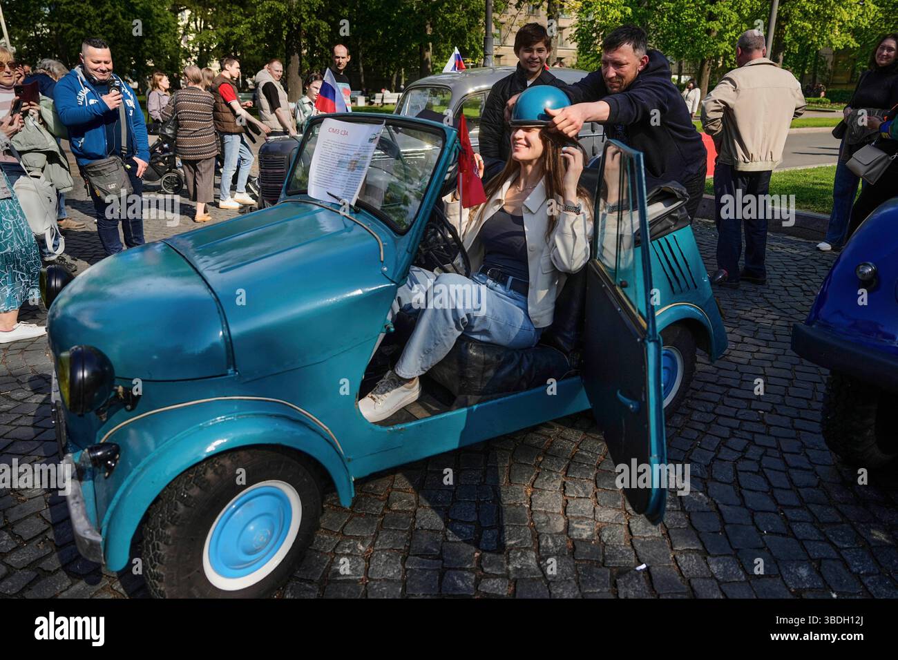 A woman sits in a Soviet era disabled access vehicle at a transport ...