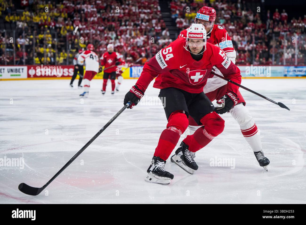 Christian Marti of, Switzerland. , . and Alexander True of Denmark during the 2025 IIHF Ice ...