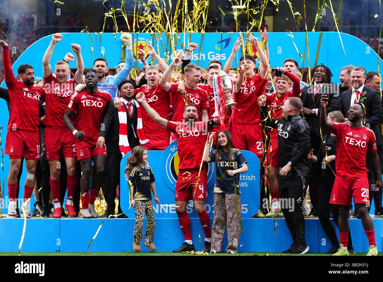 Aberdeen's Graeme Shinnie with the trophy celebrates on the pitch with ...
