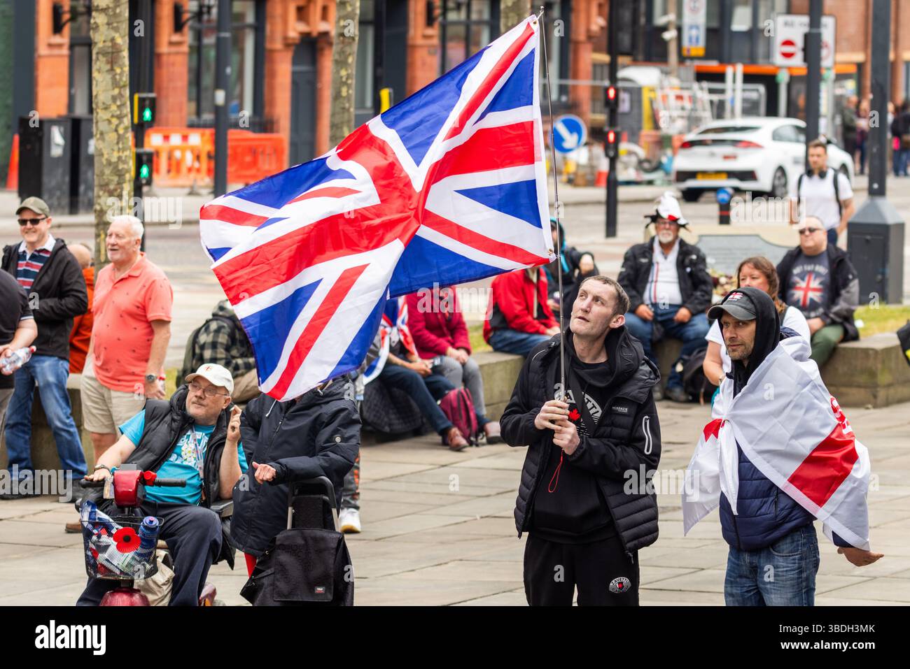 Leeds, UK. 24 MAY, 2025. Man holds Union Jack flag as the right-leaning ...