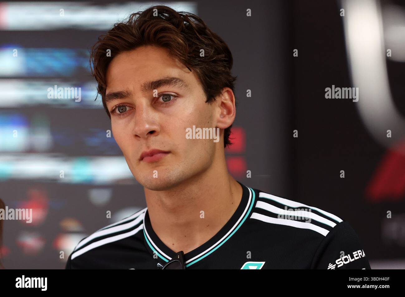George Russell of Mercedes-AMG F1 Team looks on in the Paddock during ...