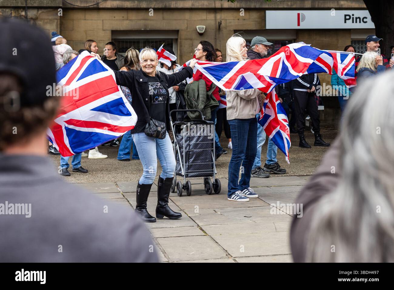 Leeds, UK. 24 MAY, 2025. People dance with Union Jack flags as the ...