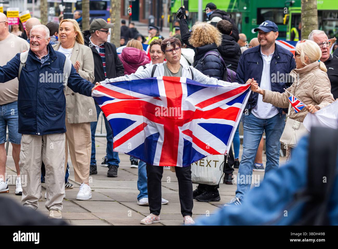 Leeds, UK. 24 MAY, 2025. People dance with Union Jack flags as the ...