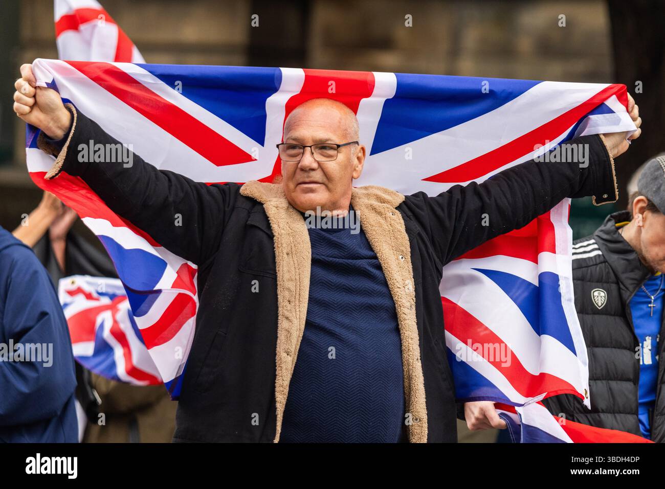 Leeds, UK. 24 MAY, 2025. Man wears Union Jack flag as the right-leaning ...