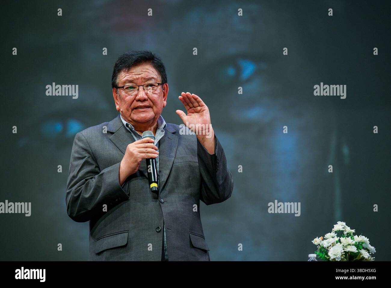 Dr. Sanduk Ruit speaks in the USA, with a powerful backdrop showing the ...