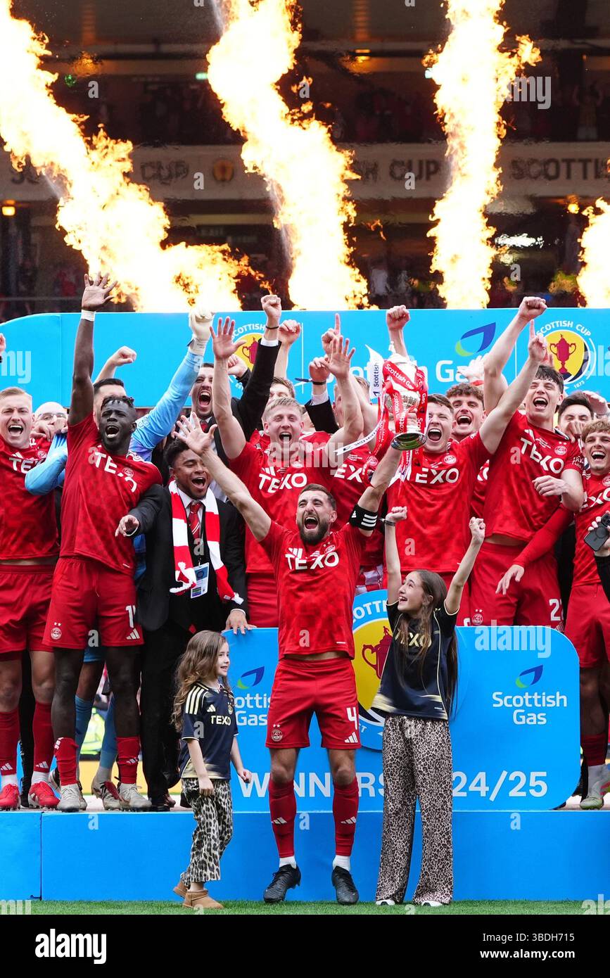 Aberdeen's Graeme Shinnie with the trophy celebrates on the pitch with ...
