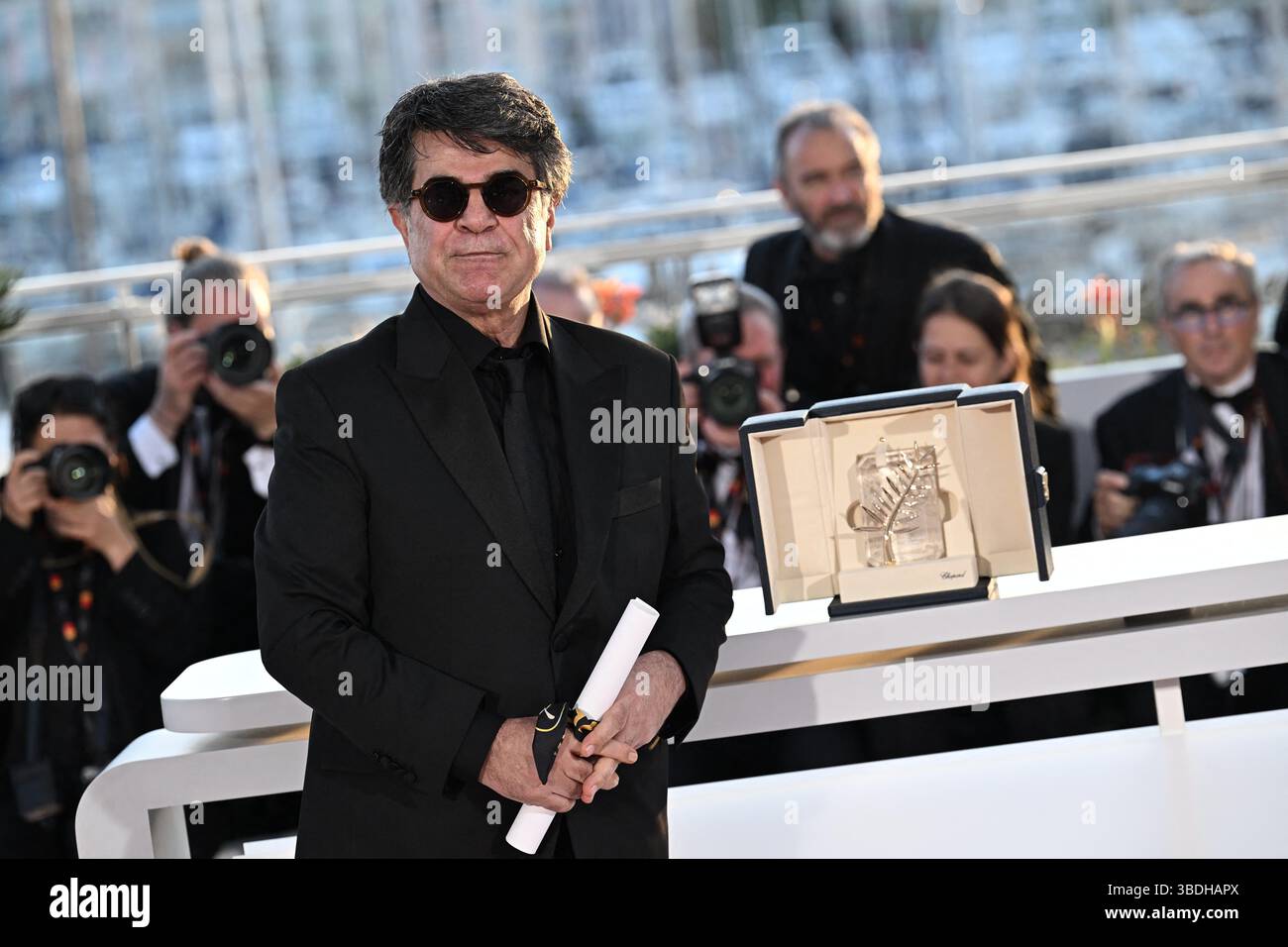 Iranian director and screenwriter and producer Jafar Panahi poses with the trophy during a ...