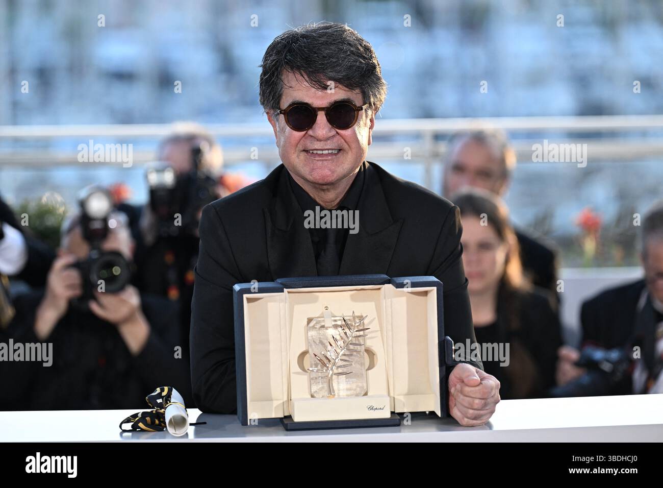 Iranian director and screenwriter and producer Jafar Panahi poses with the trophy during a ...