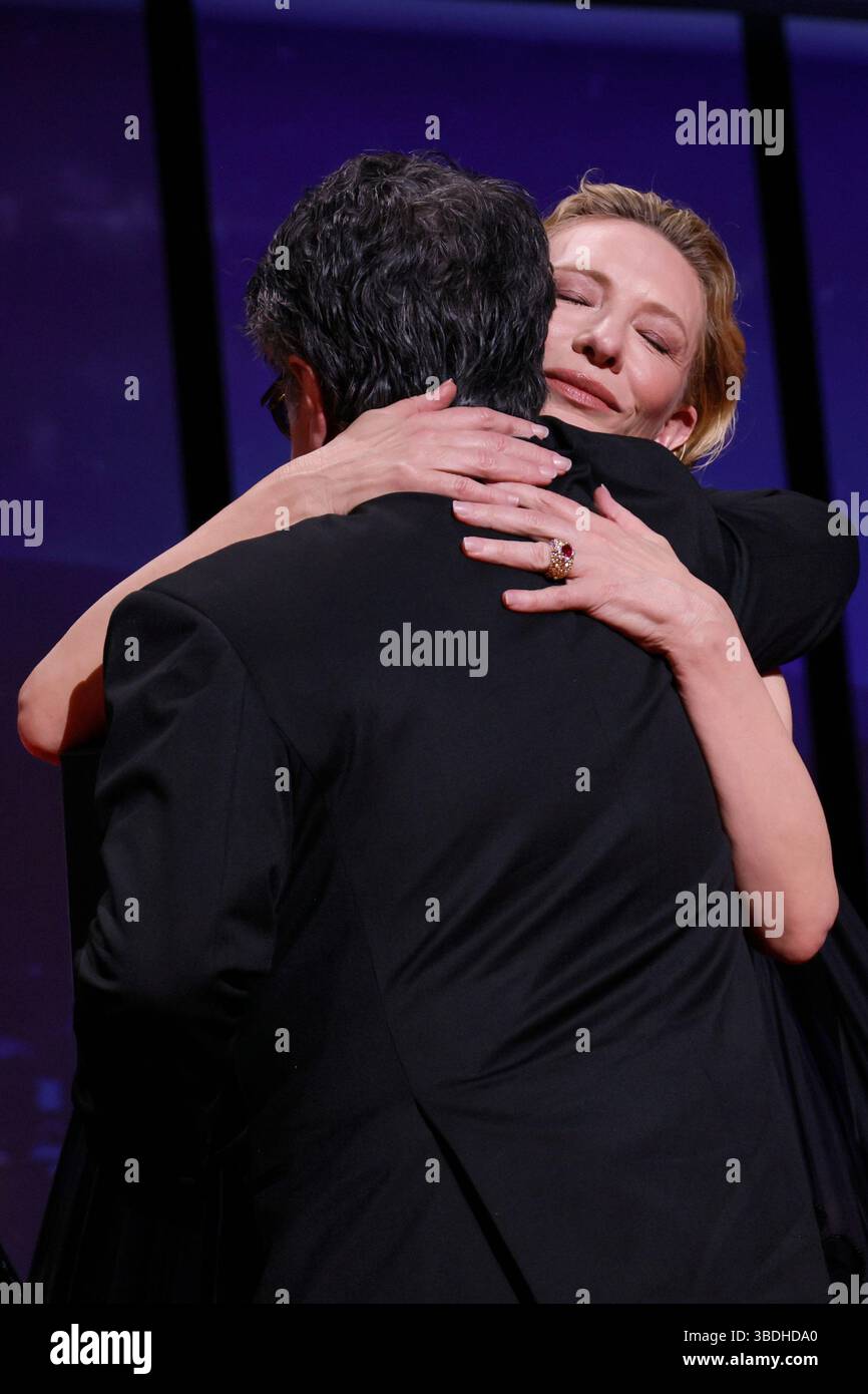 Cate Blanchett, right, embraces director Jafar Panahi, winner of the ...