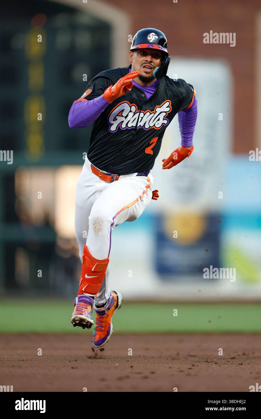 Willy Adames #2 of the San Francisco Giants runs to third base on a ...