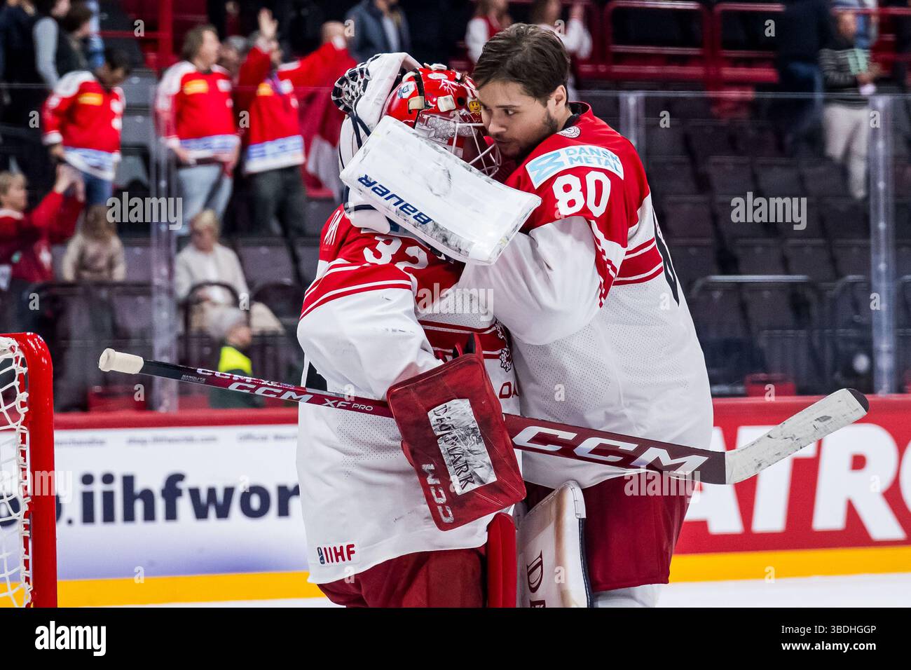 Goaltender Sebastian Dahm and goaltender Frederik Dichow of, Denmark. , . look dejected after ...