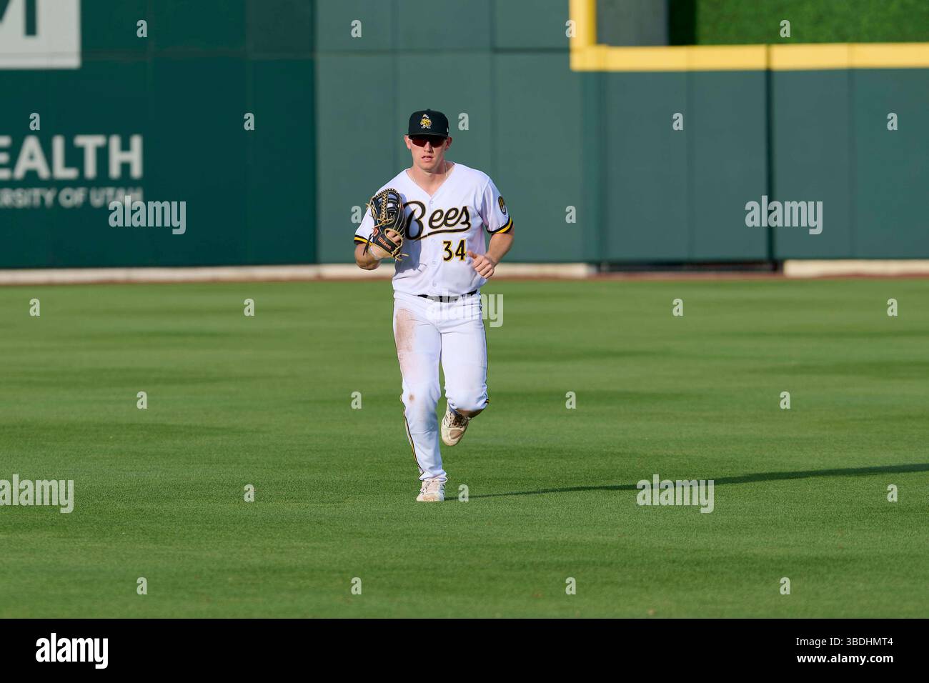Tucker Flint (34) of the Salt Lake Bees trots off the field between ...