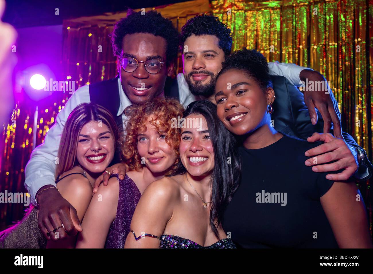 Group of cheerful elegant friends posing together for a photo at ...