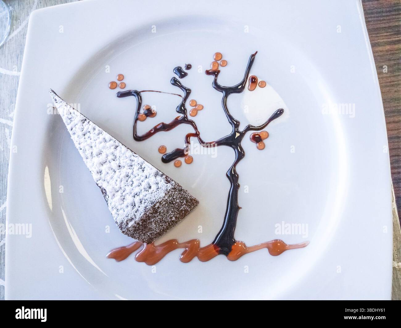 A typical italian slice of cake caprese made of chocolate and almonds ...
