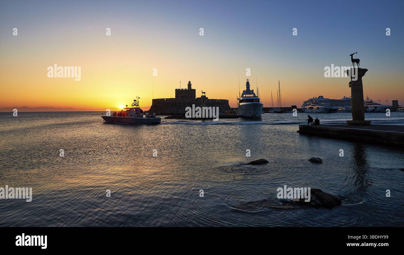 Sunrise in the harbour with boats and an impressive fortress silhouette ...