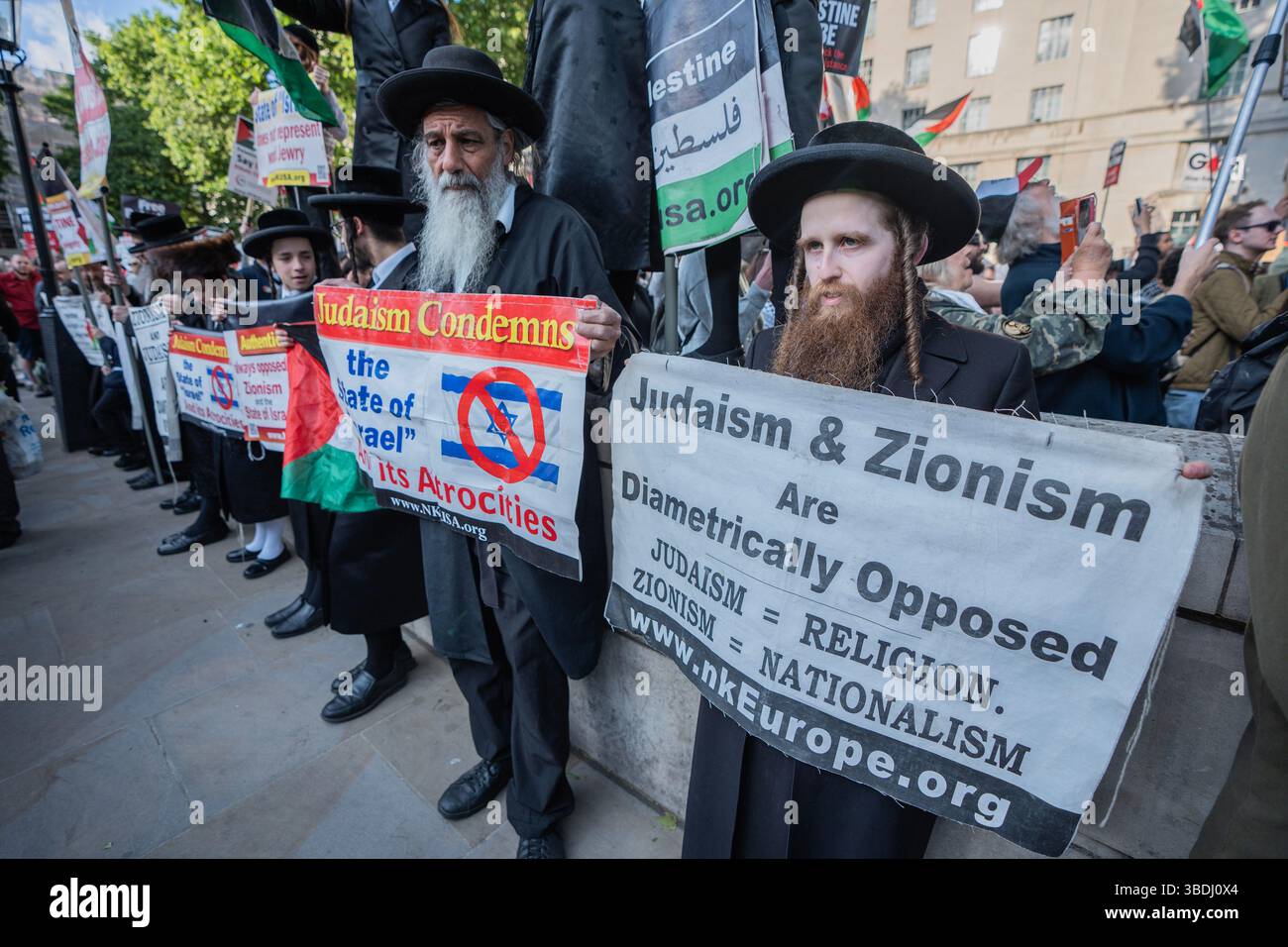 London, UK. 23rd May, 2025. Orthodox Jews hold banners during the ...