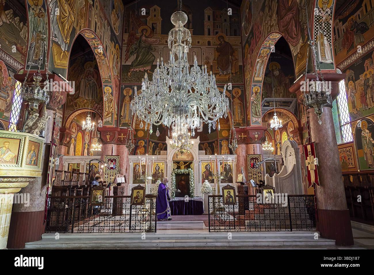Magnificent altar area with large chandelier and icons in a decorated ...