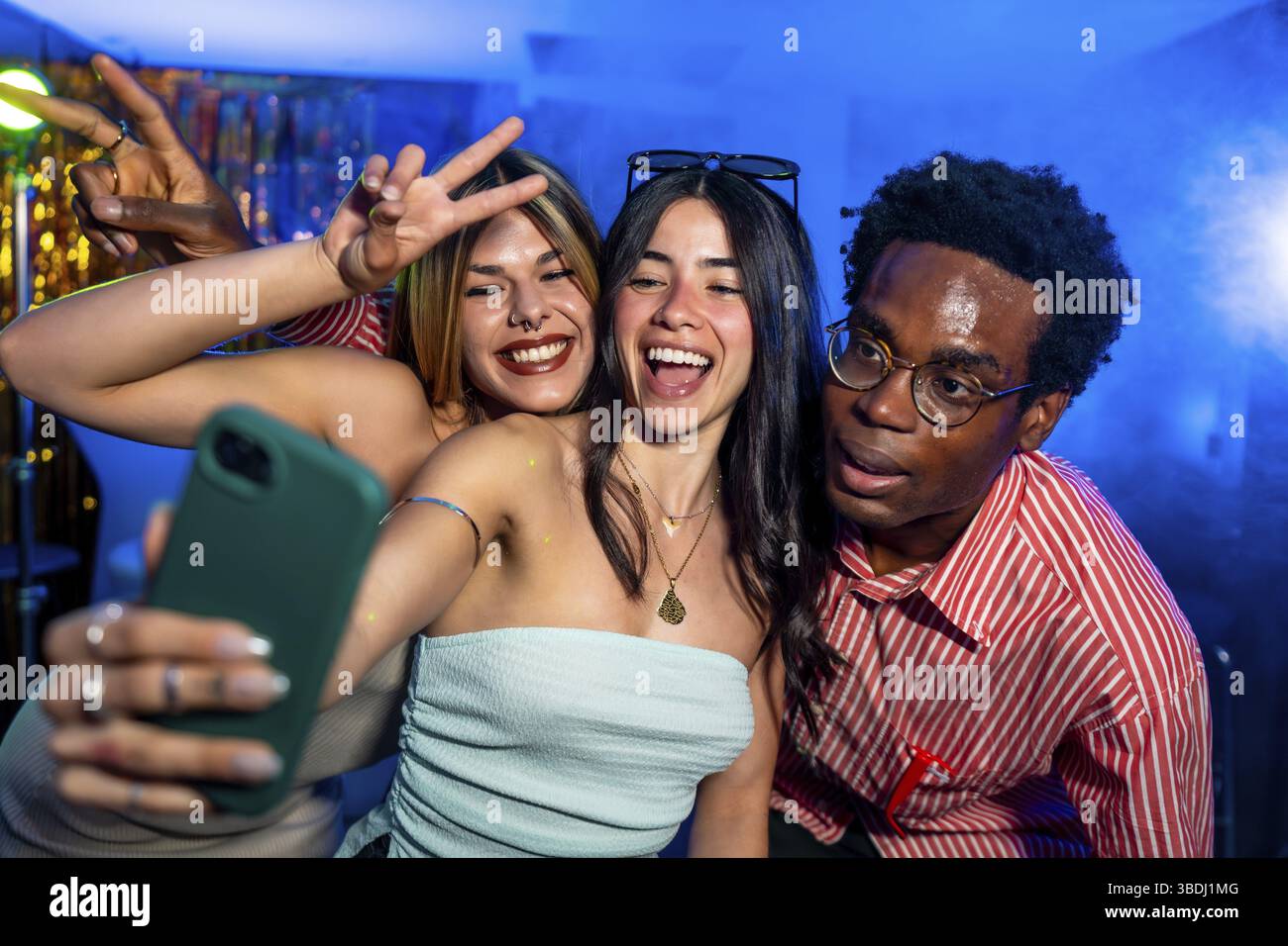 Happy multi ethnic friends taking a selfie while partying in a ...