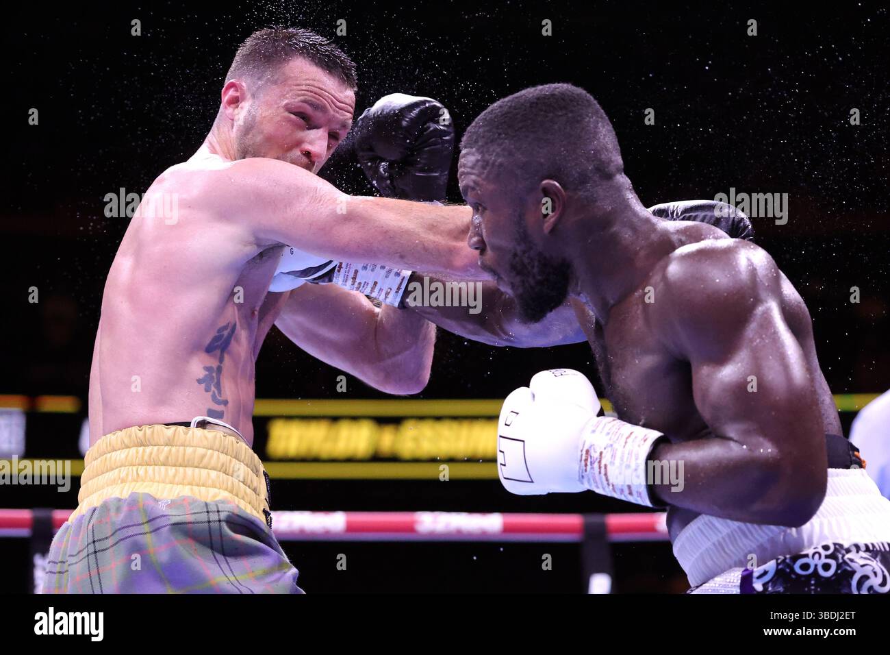 Josh Taylor (left) in action against Ekow Essuman in the WBO Global Welterweight bout at the OVO ...