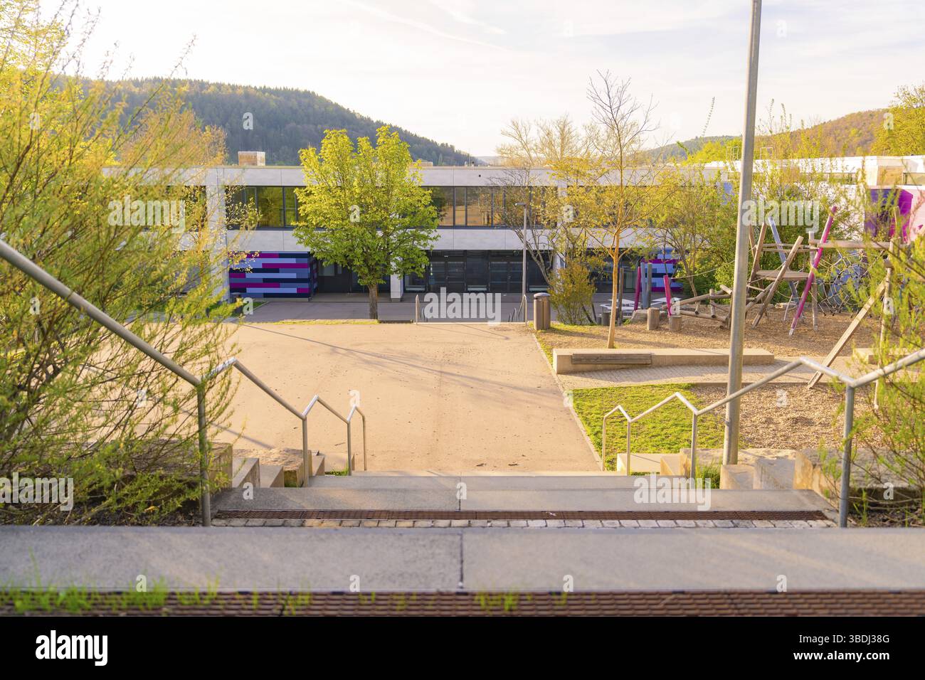 A playground and modern school buildings in the sunshine with ...