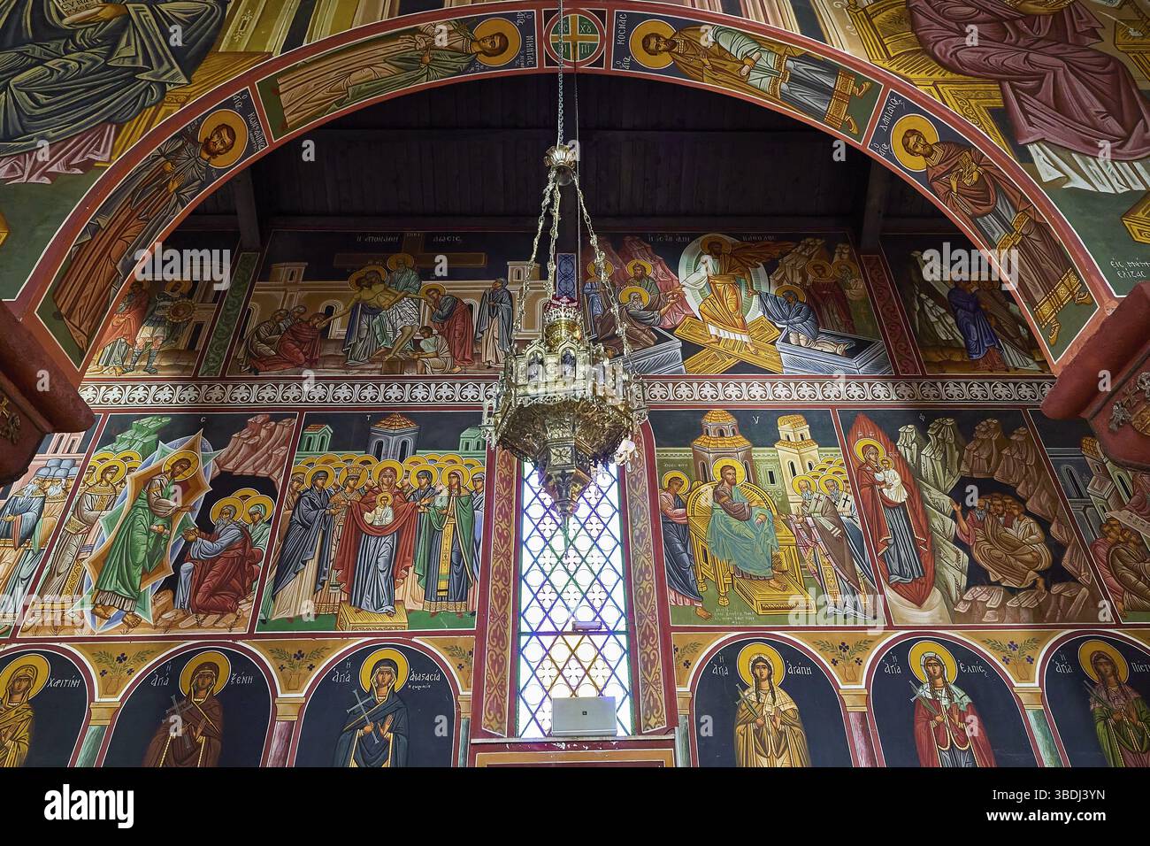 Artfully designed church interior with icons and large murals around a ...