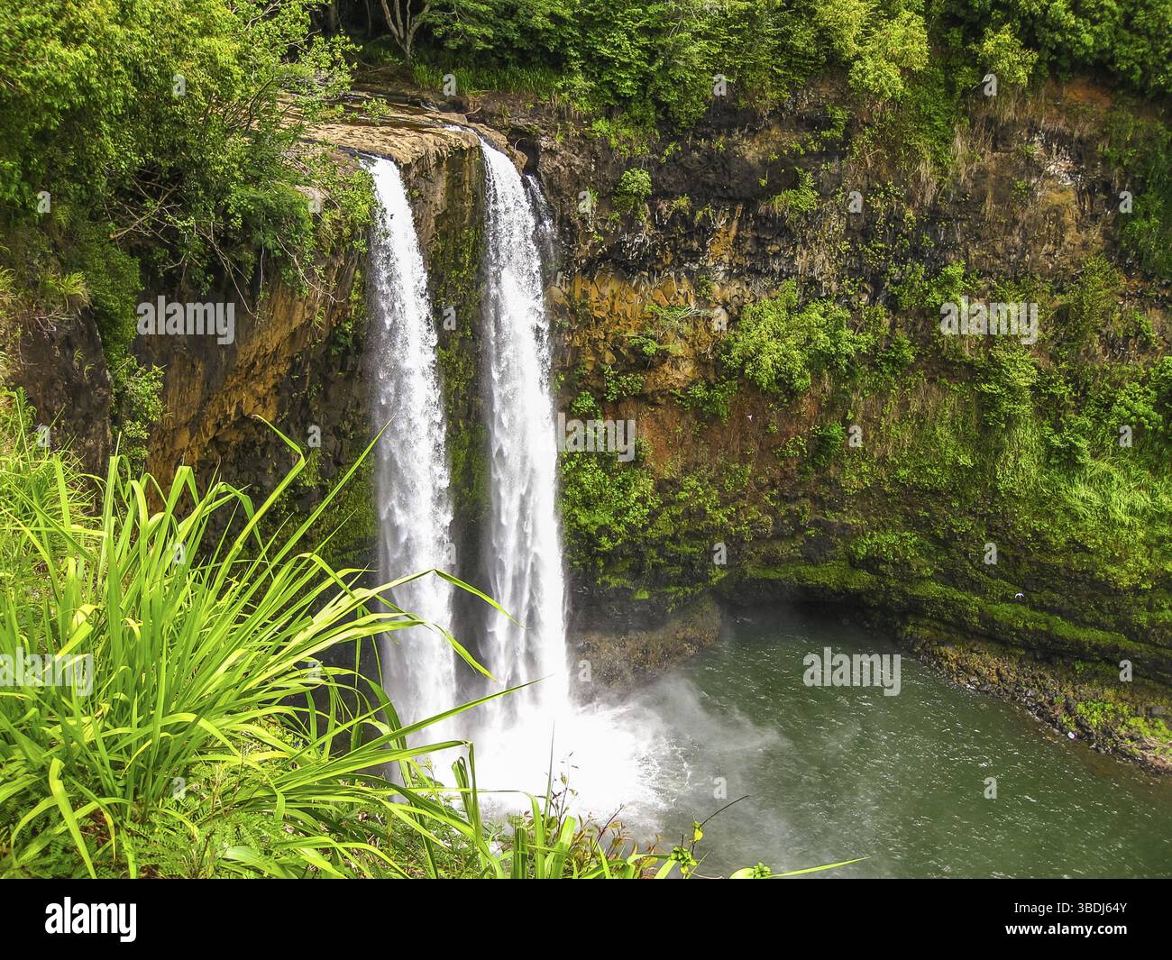 Aerial view of tropical Manawaiopuna Falls also called Jurassic Park ...
