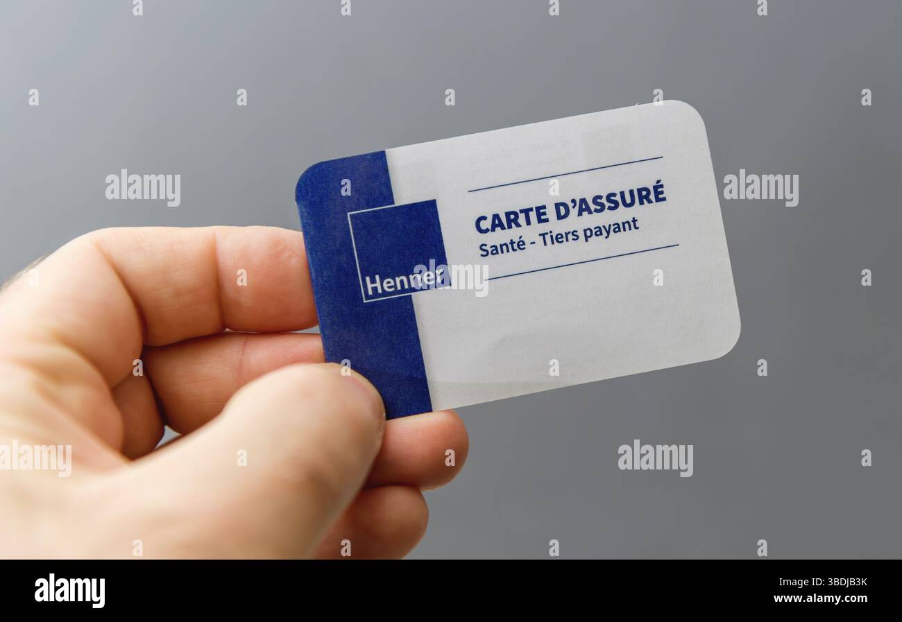 Paris, France - Mar 9, 2025: Hand holding a French health insurance ...