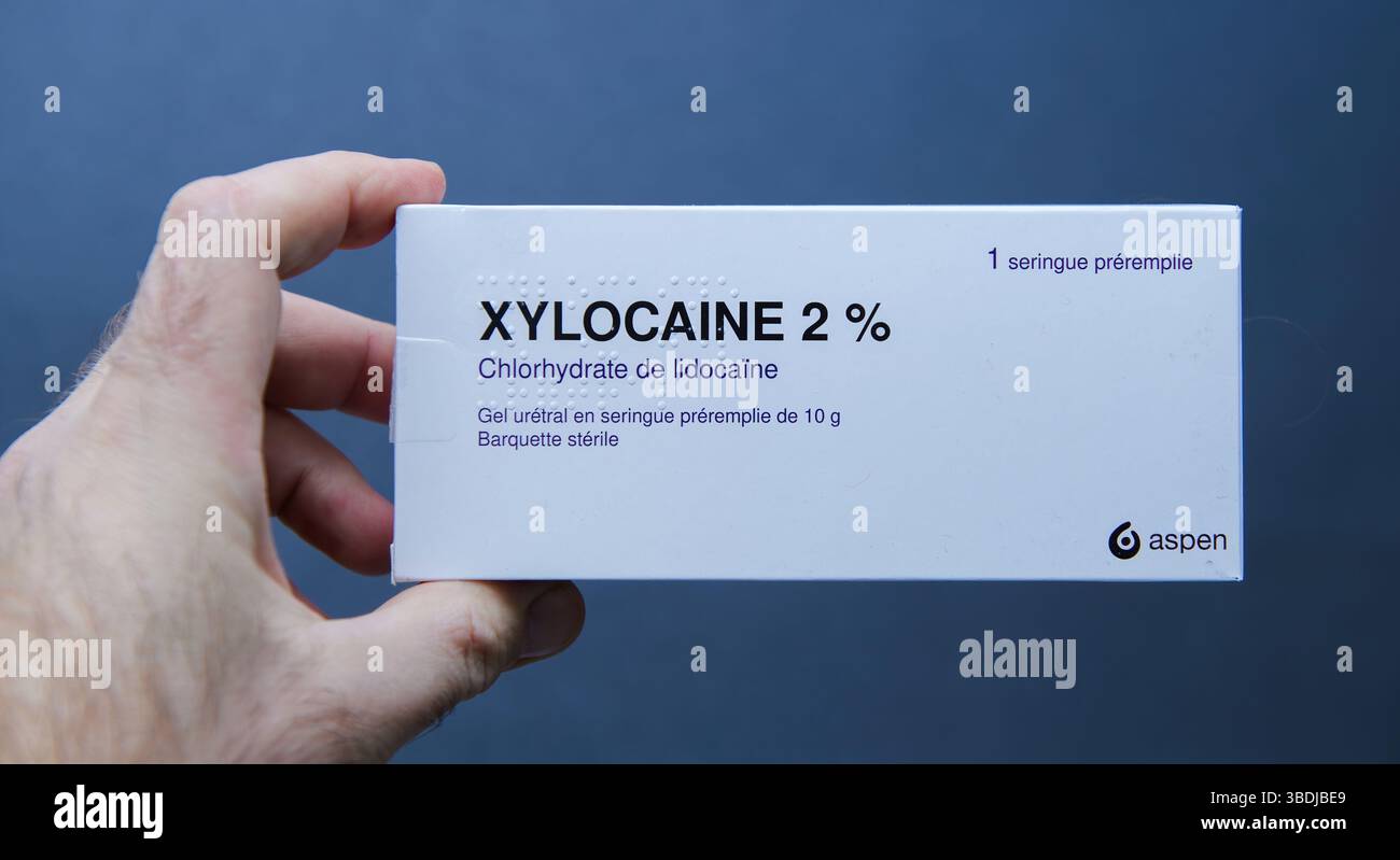 Paris, France - Mar 9, 2025: A hand holds a box of Xylocaine 2percent ...