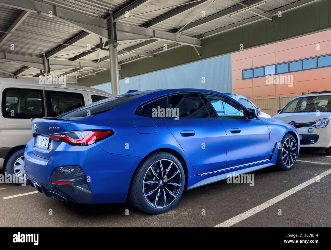 Paris, France- Mar 28, 2025: A matte blue BMW M440i parked neatly in a ...