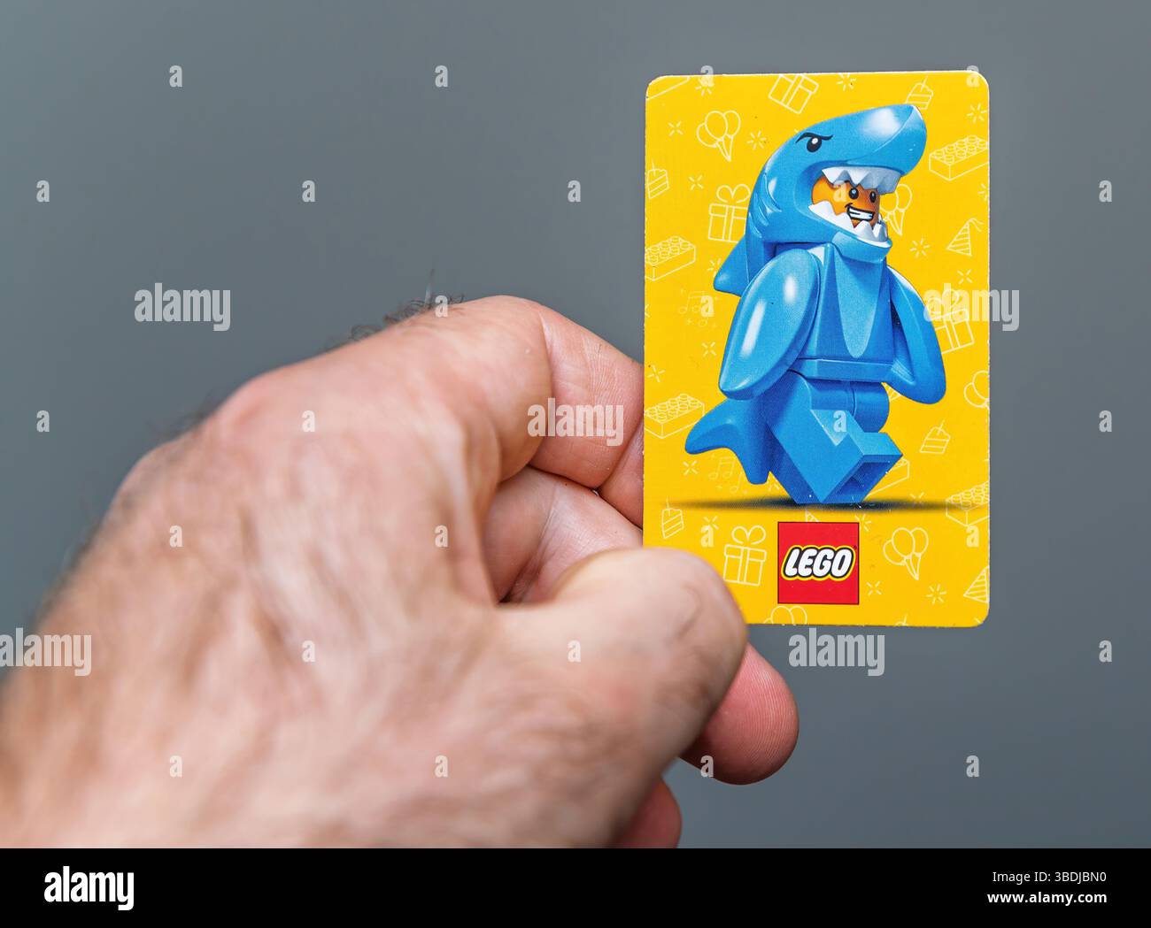 Paris, France - Apr 18, 2025: A close-up of a hand holding a colorful ...
