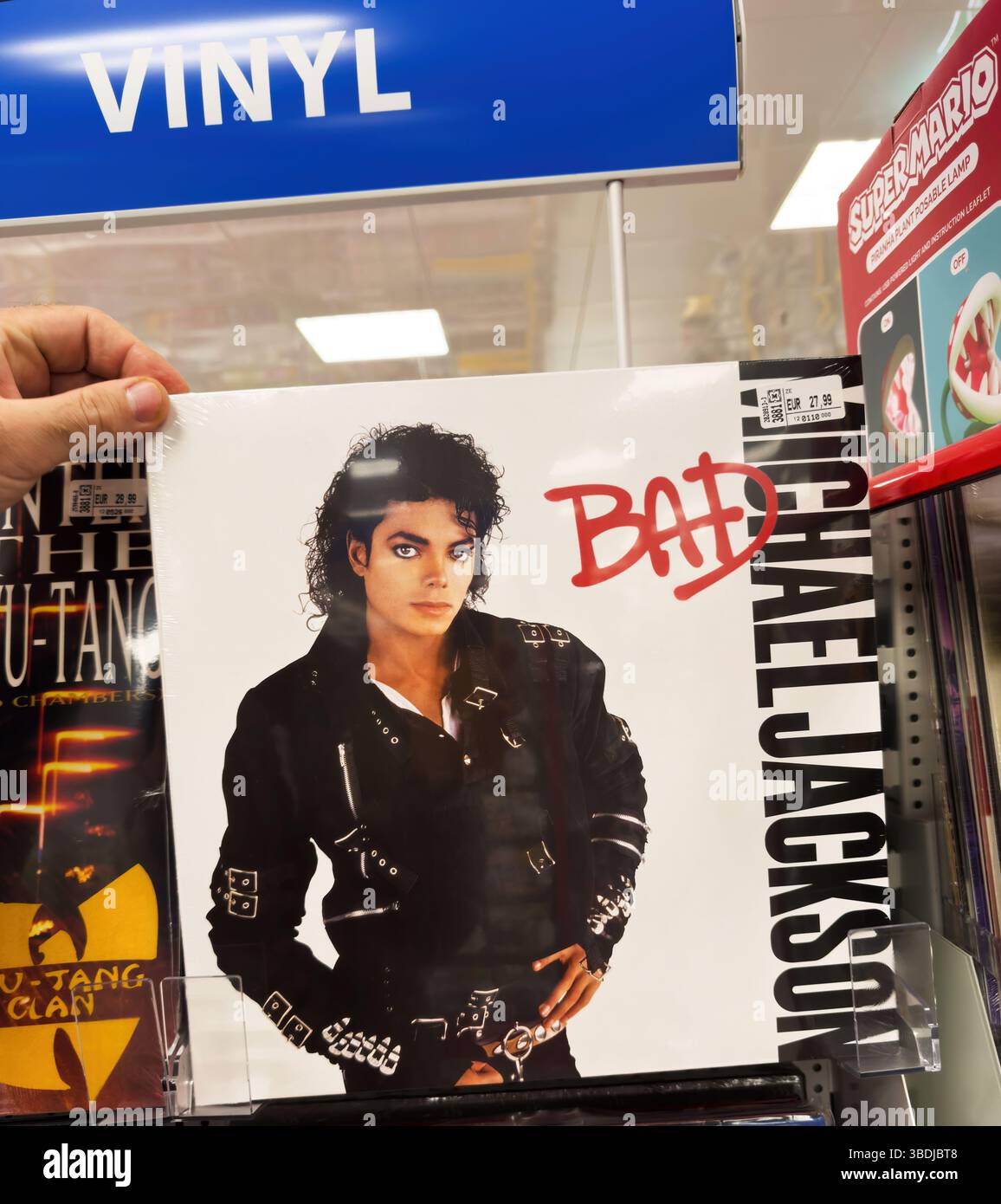 Berlin, Germany - Apr 12, 2025: A hand holds Michael Jackson Bad vinyl ...