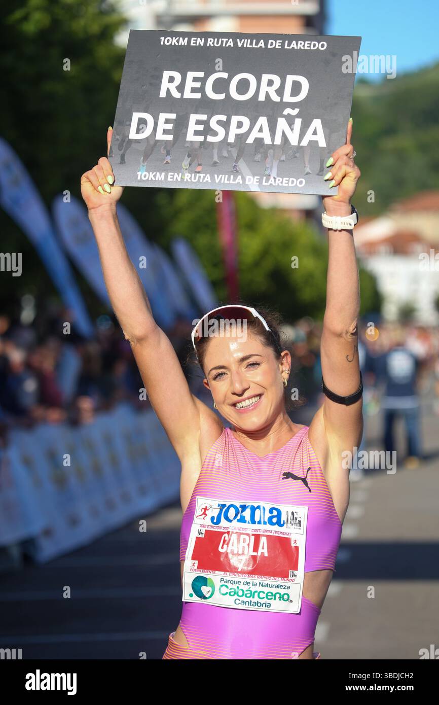 Laredo, Spain, May 24, 2025: Athlete Carla Gallardo (7) poses with the Spanish 10K record sign ...