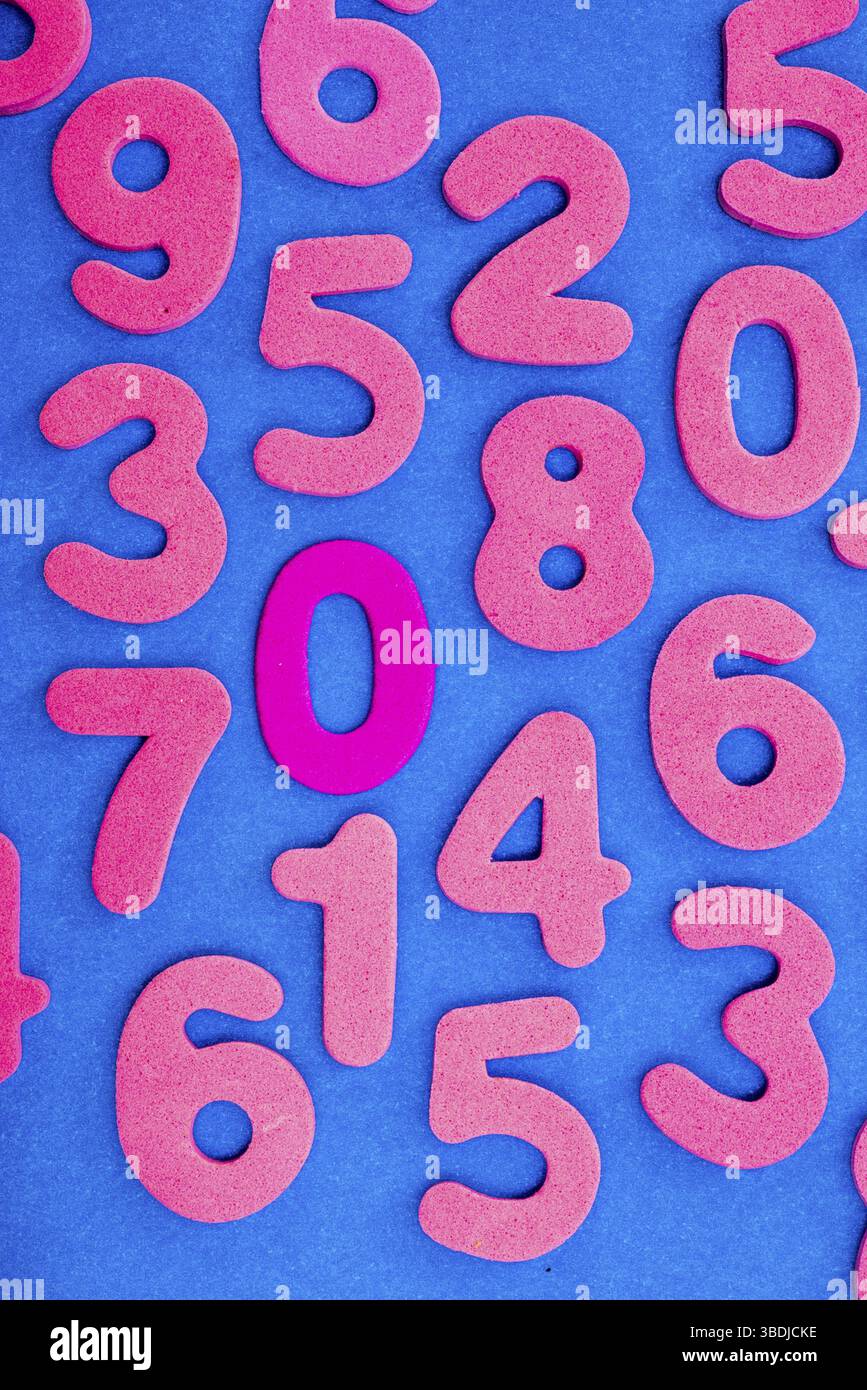 Single digit numbers in pink are spread over a blue backgrond in ...