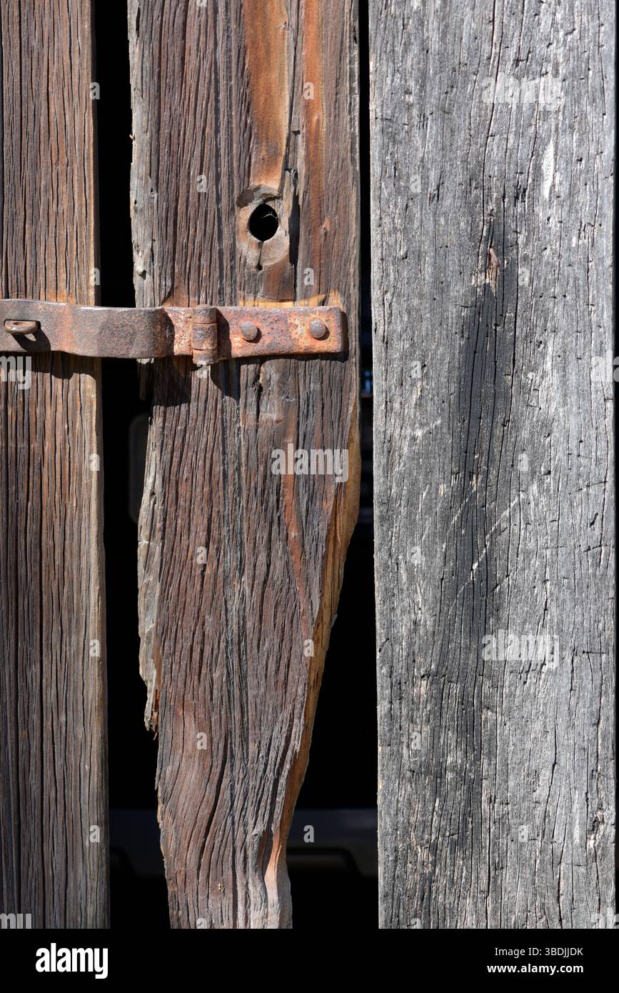 Old unpainted wooden gate of farmhouse basement, with rusty hardware ...