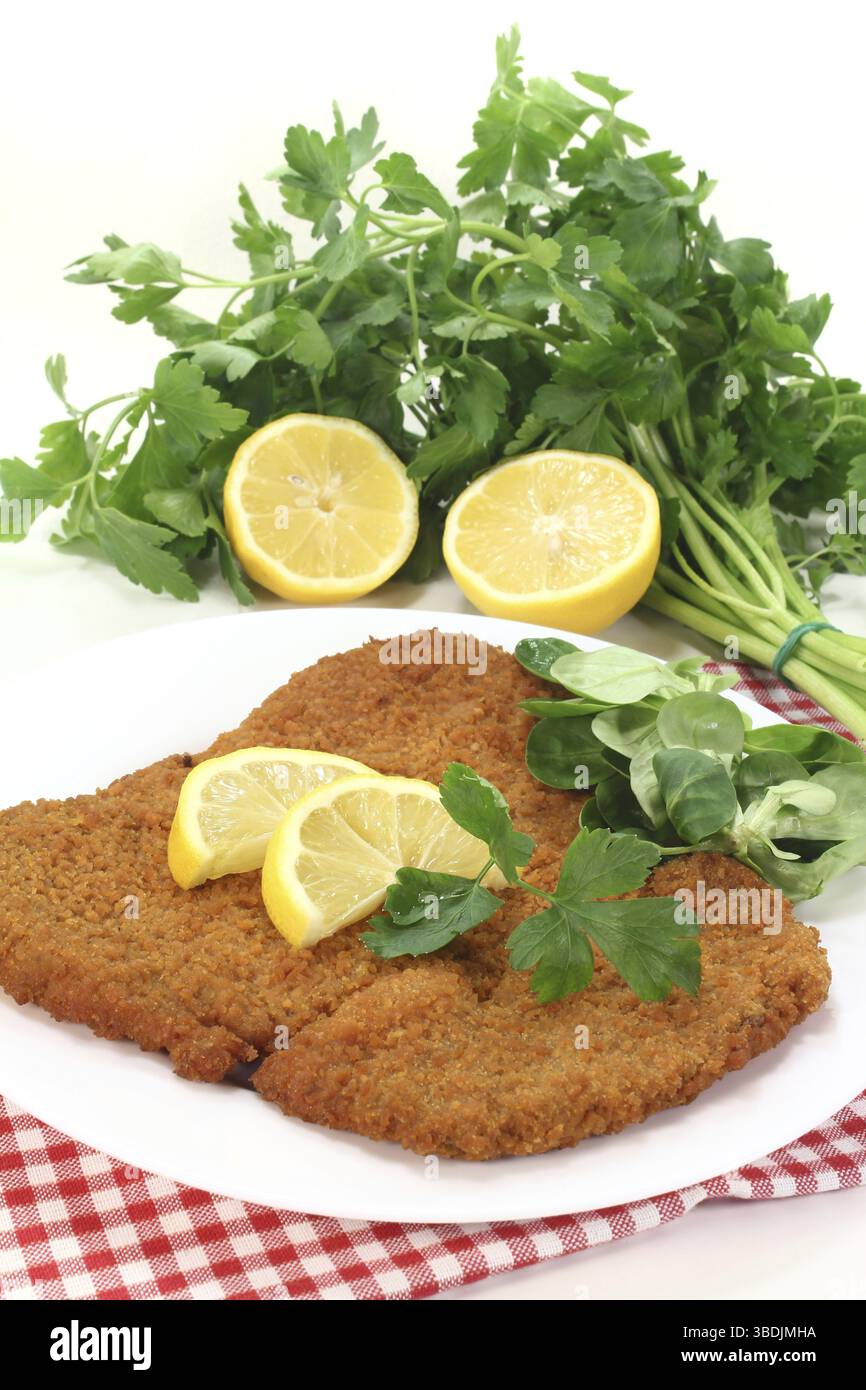 Fried Wiener schnitzel with lemon slices and parsley Stock Photo - Alamy