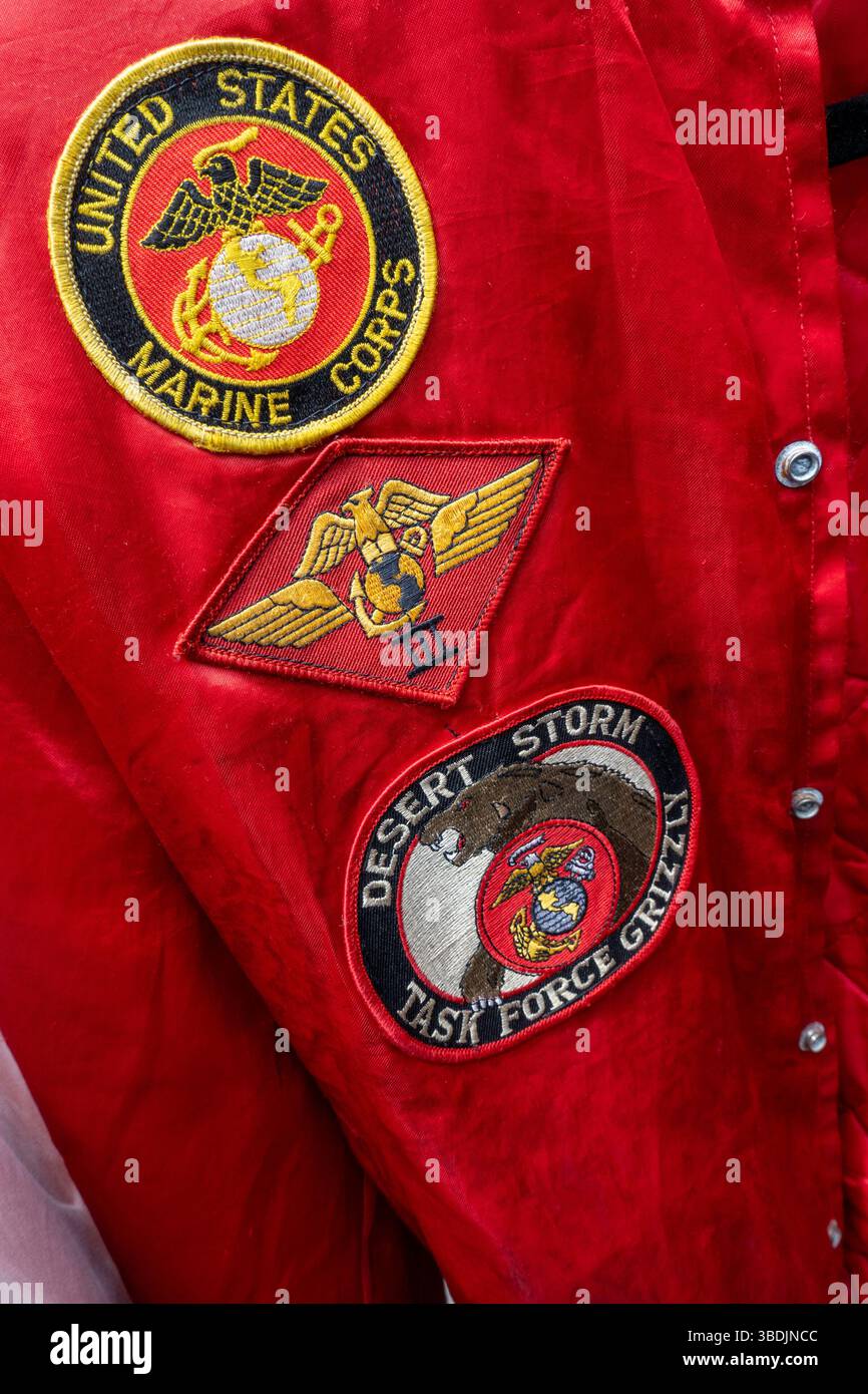 Patches on a red jacket from the US Marine involvement in Desert storm ...
