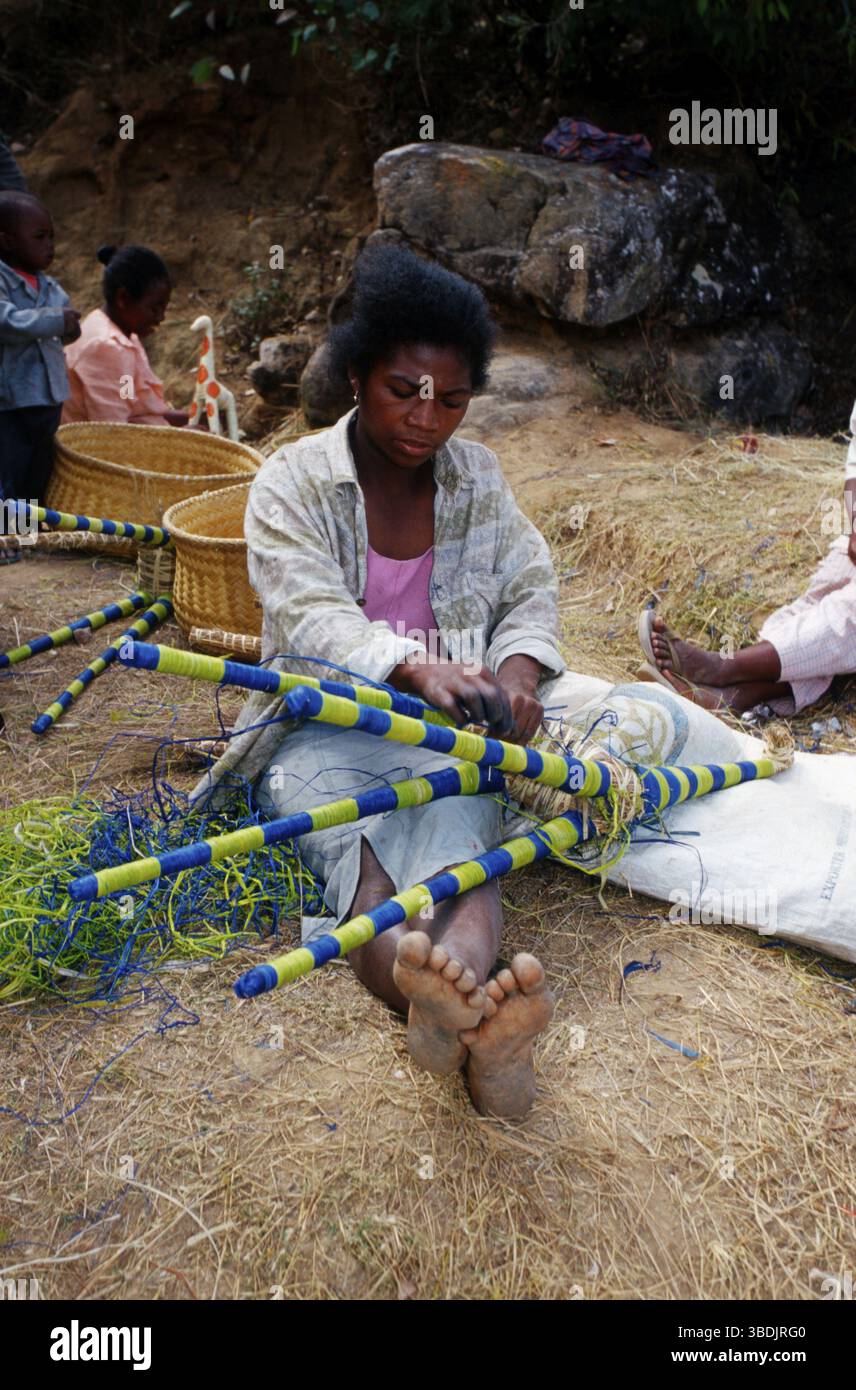 Women producing figures of bast, Madagascar, Woman producing figures of ...