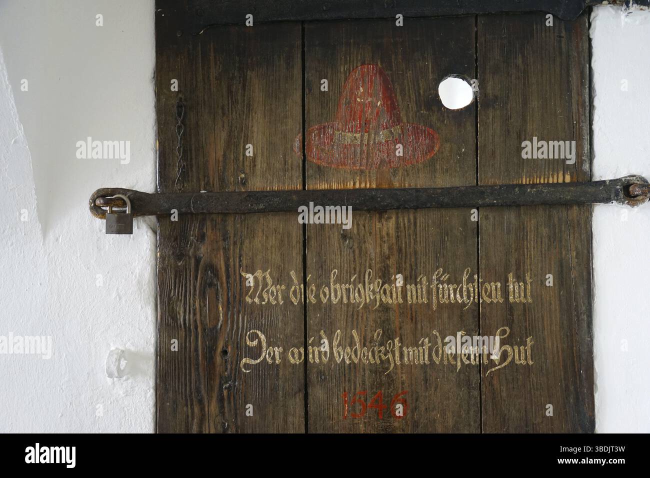 Inscription, red hat, old wooden door, former entrance to the ...