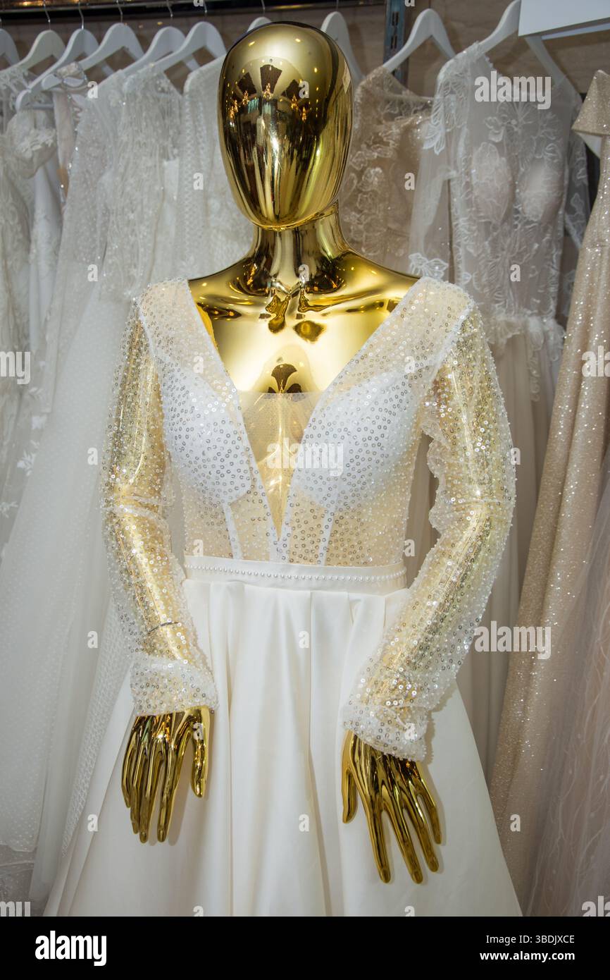 Wedding dress on a golden mannequin Stock Photo - Alamy