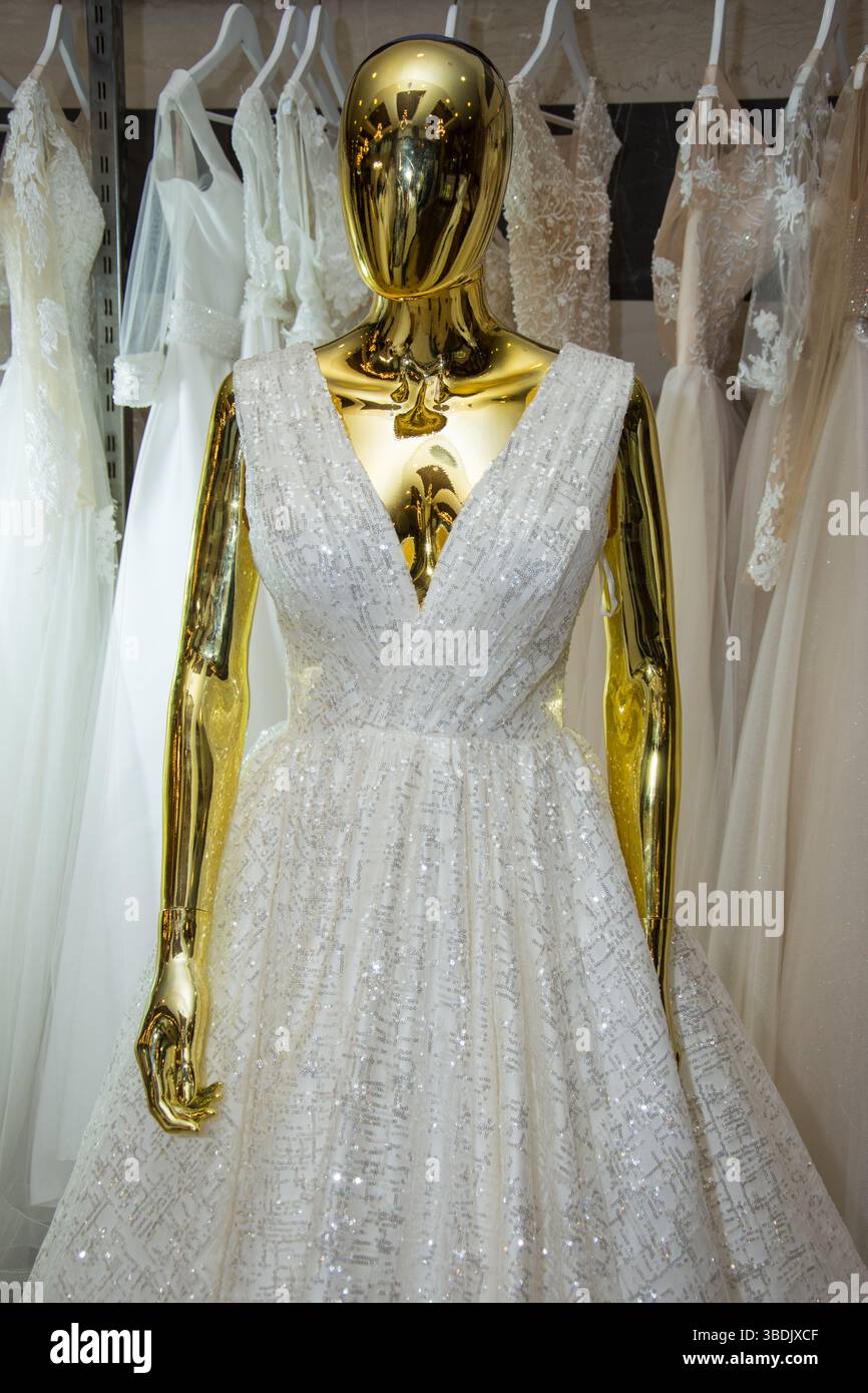 Wedding dress on a golden mannequin Stock Photo - Alamy