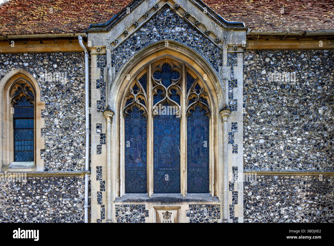 Detailed view of a large Gothic stained-glass window with intricate ...