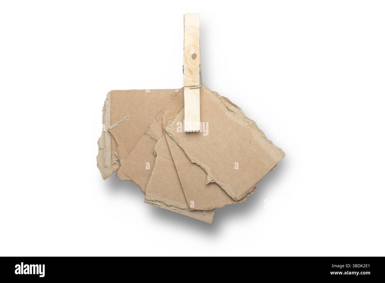 Stack of ripped pieces of card board, holding together of a clothespin ...