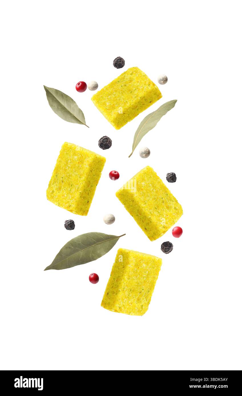 Bouillon cubes and spices falling on white background Stock Photo - Alamy