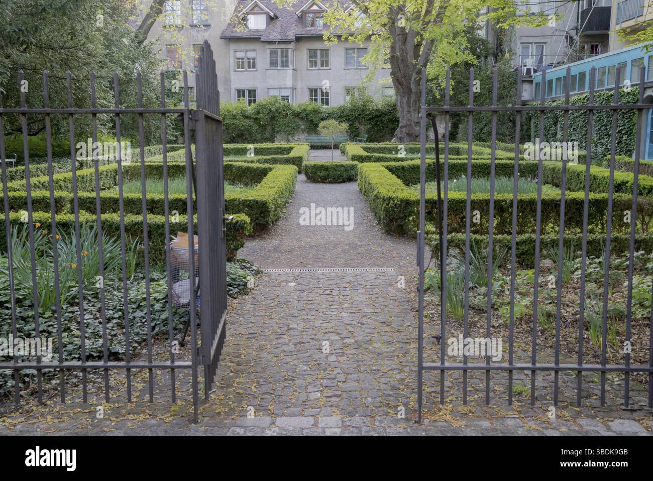 Horizontal view of a small gated city park in the Swiss town of ...