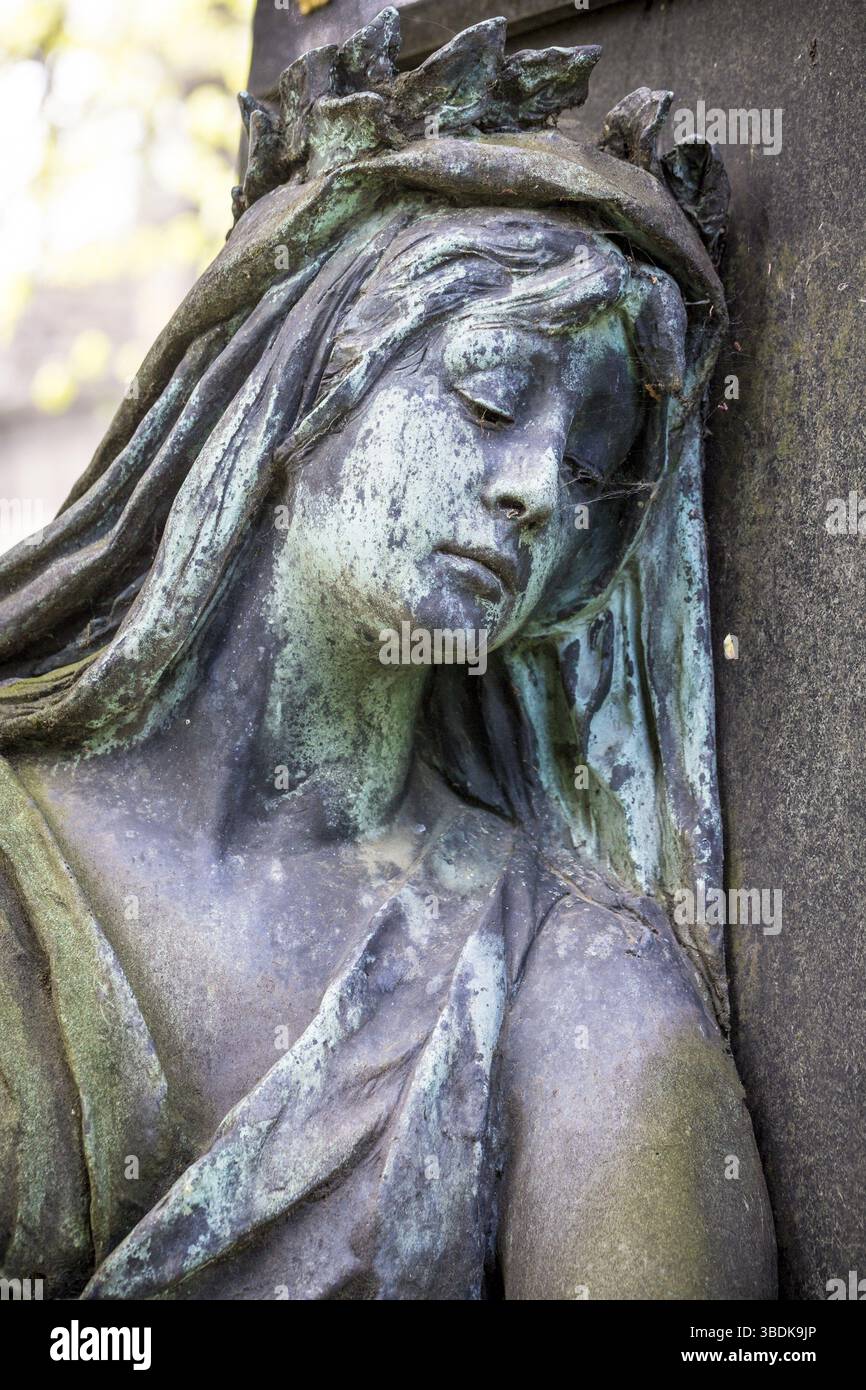 Bronze sculpture of a sad woman Stock Photo - Alamy