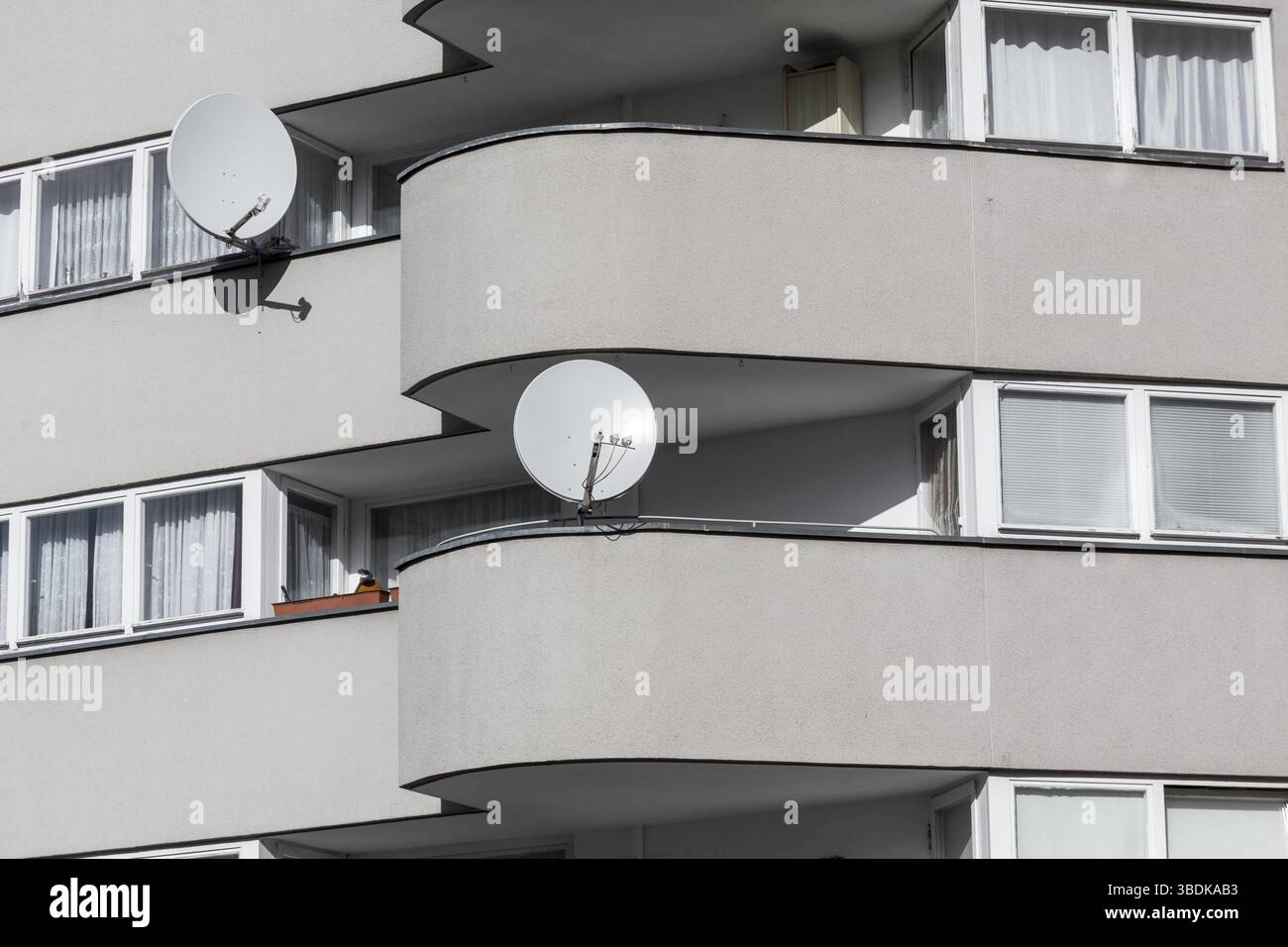 Detail of a sparse gray house with two satellite dishes Stock Photo - Alamy