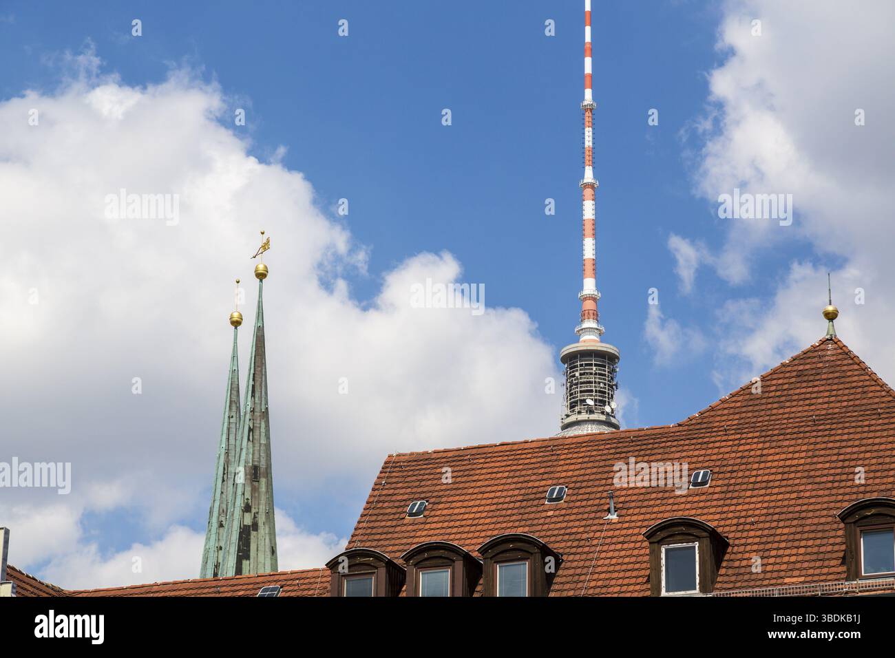Steeple and top of the berlin tv tower behind a red roof Stock Photo ...