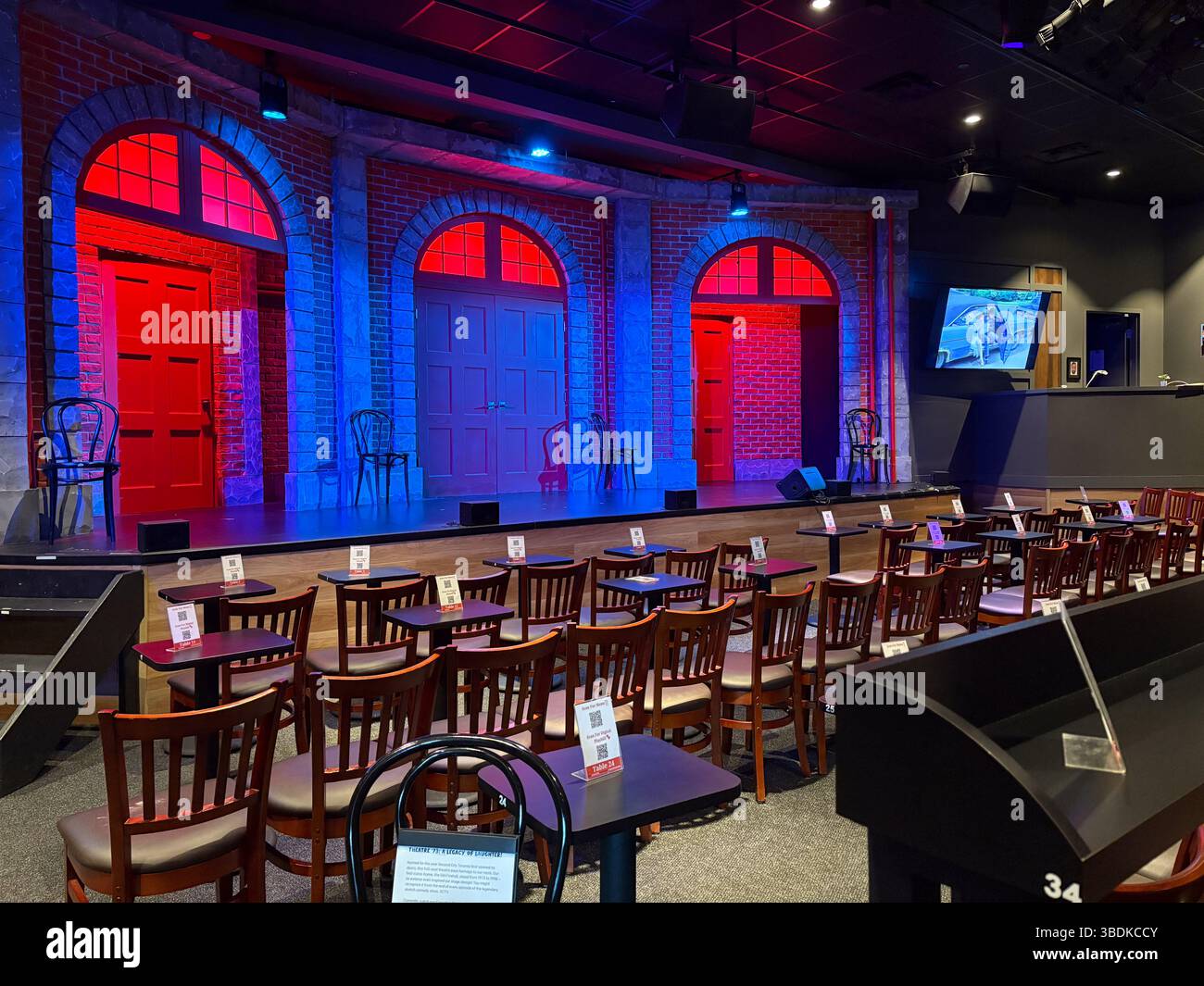 Second City Toronto, empty comedy club interior with stage, red doors ...