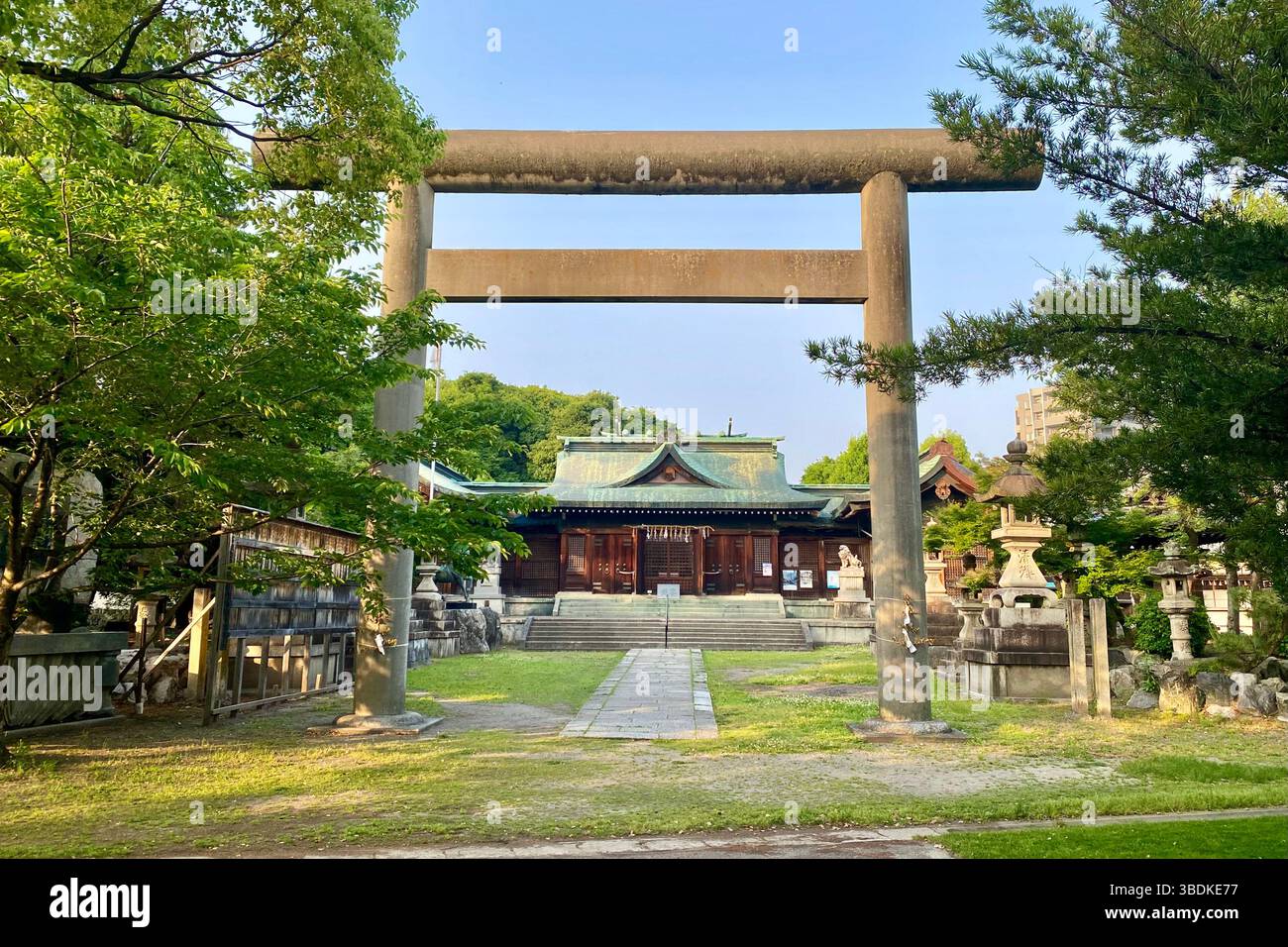 Traditional Japanese temple surrounded by lush green trees in Ogaki ...