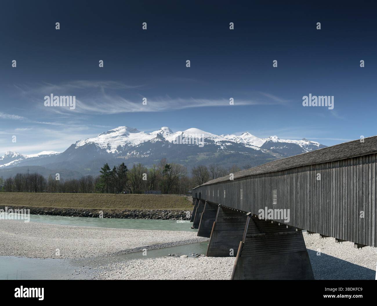 old wooden covered bridge crossing the Rhine river from Liechtenstein ...
